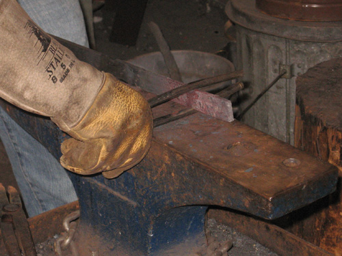 Hammering down on the arms creates a pair of indentations on each edge ...